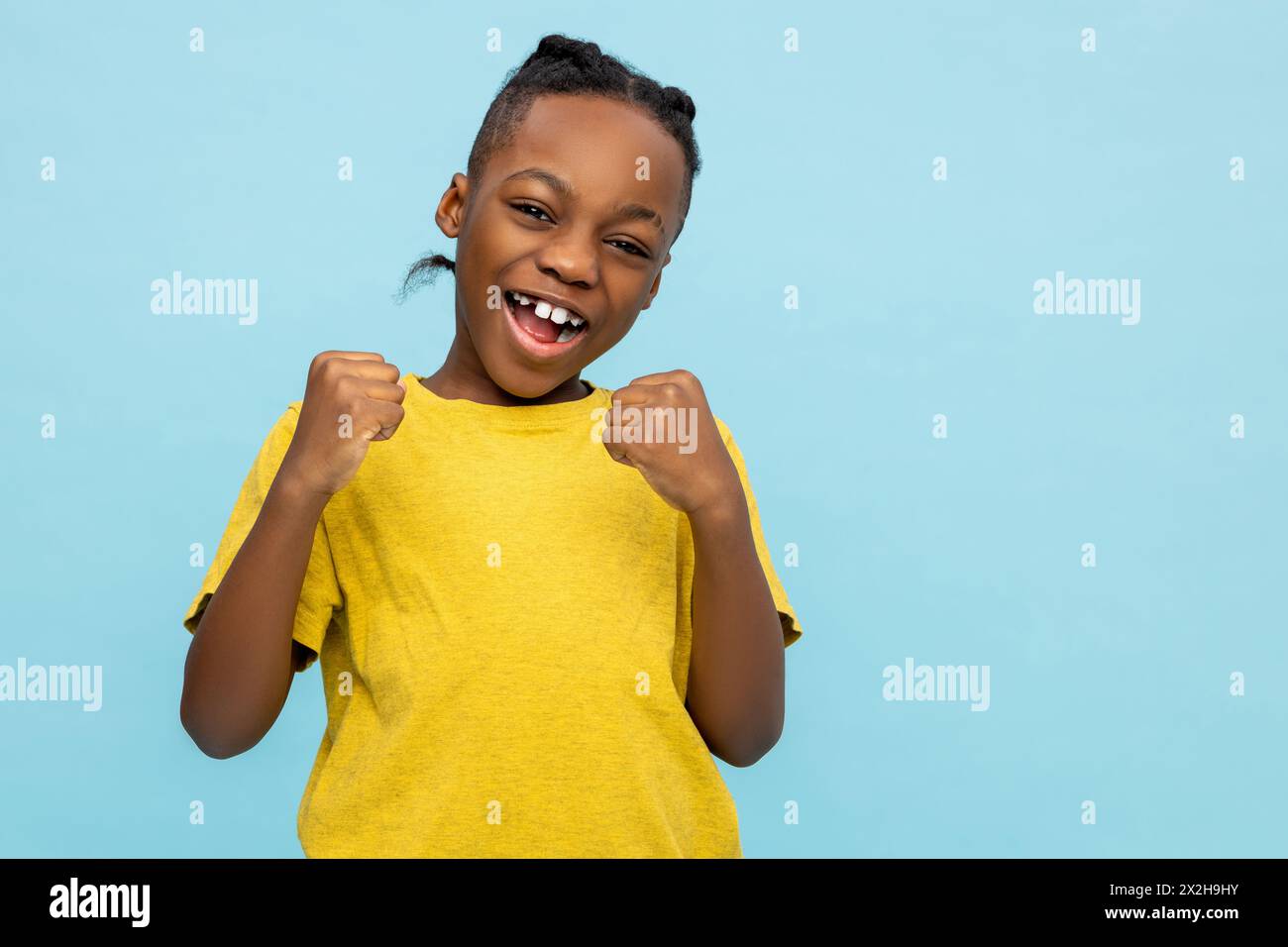 Satisfied African American little boy celebrating his success Stock ...