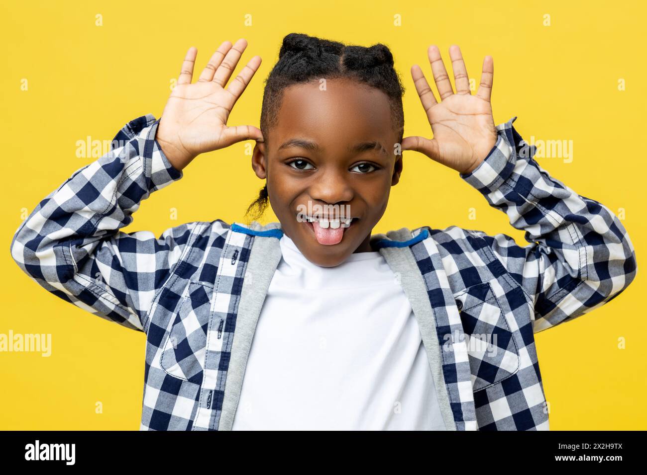 Boy in checkered shirt looking funny and happy Stock Photo - Alamy