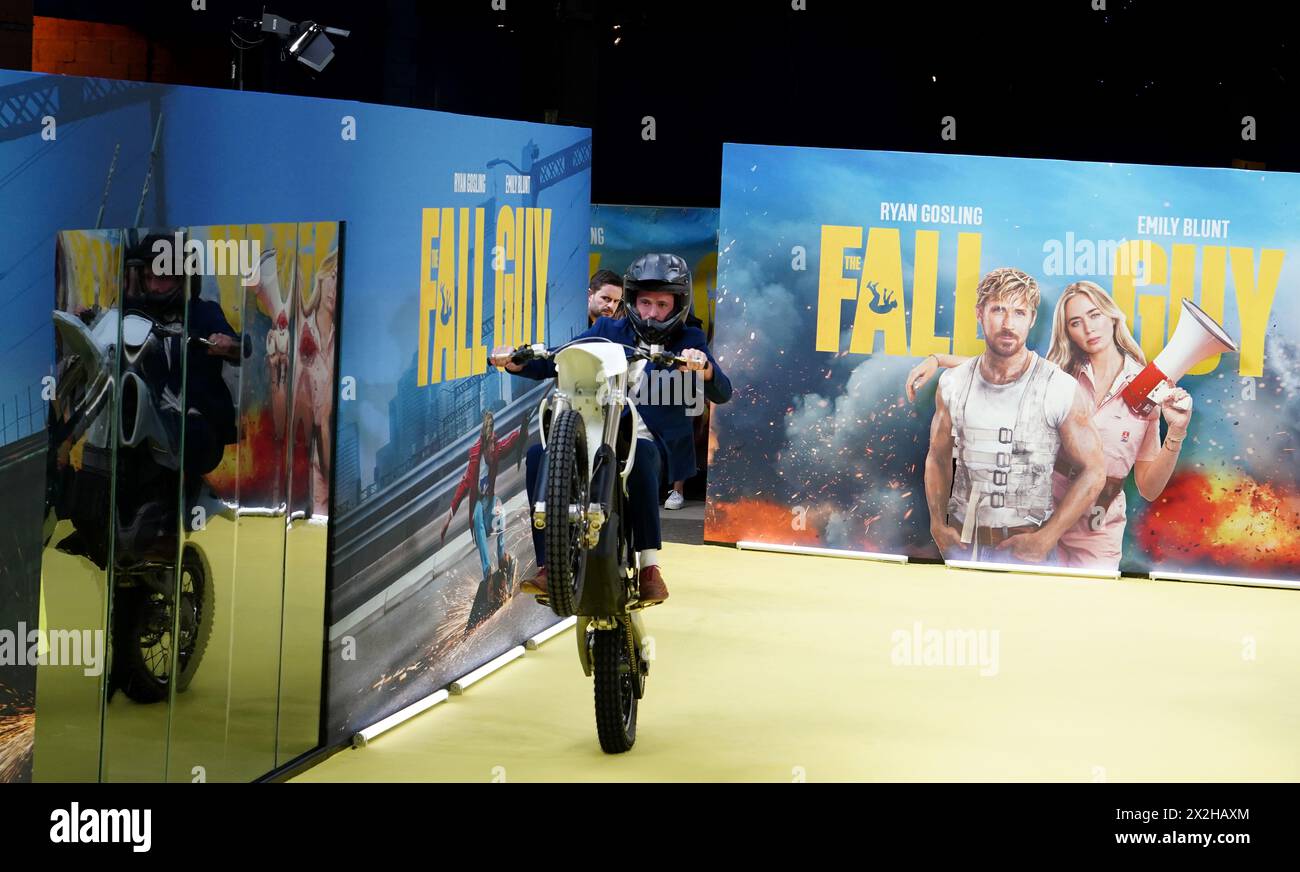 A stunt man performs a wheelie on a motorbike at a special screening of ...