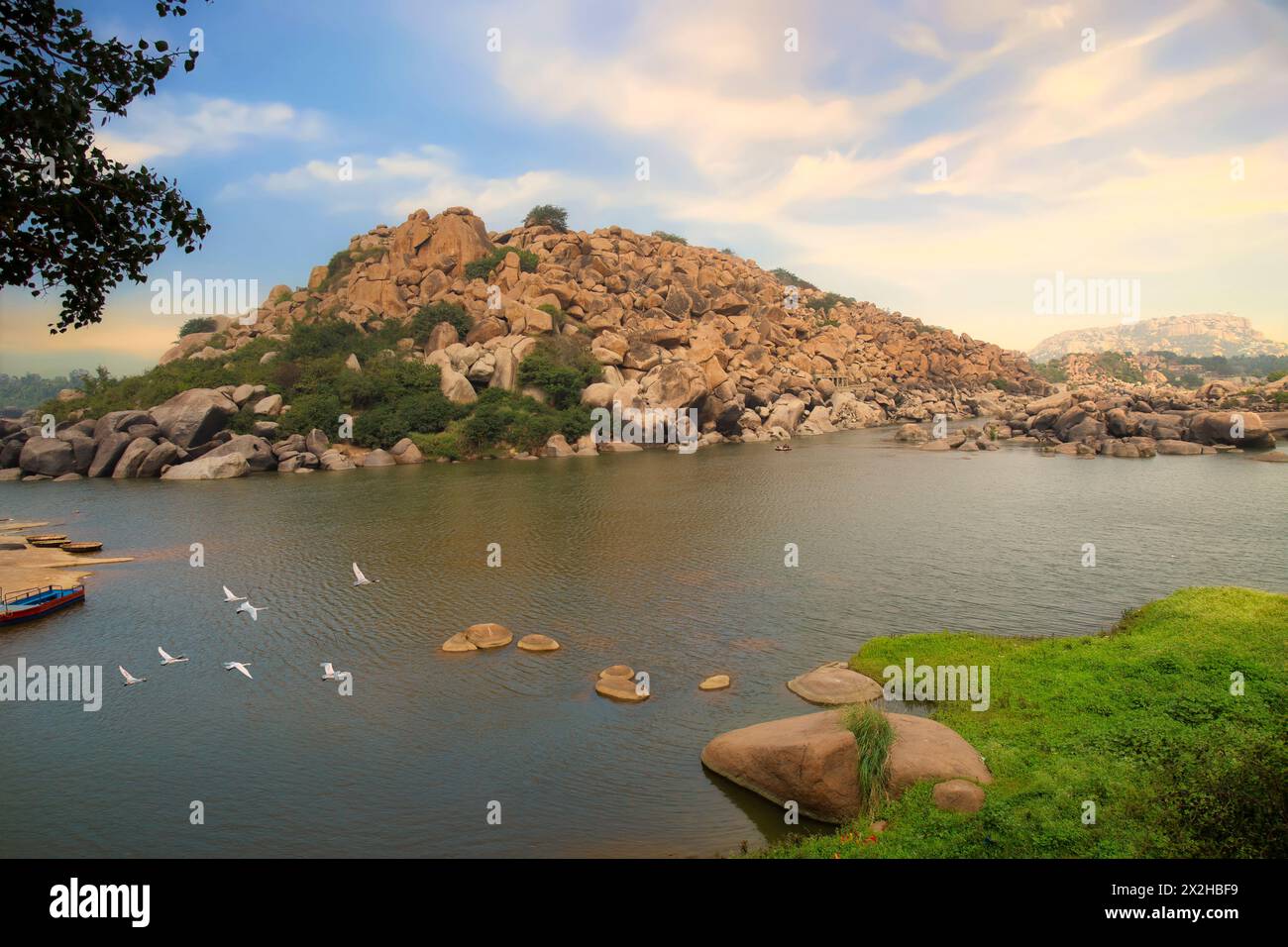 Beautiful Tungabhadra river with scenic mountain landscape at sunset at ...