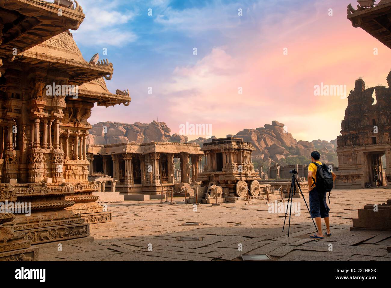 A male Tourist photographer at the ancient stone architecture ruins of ...