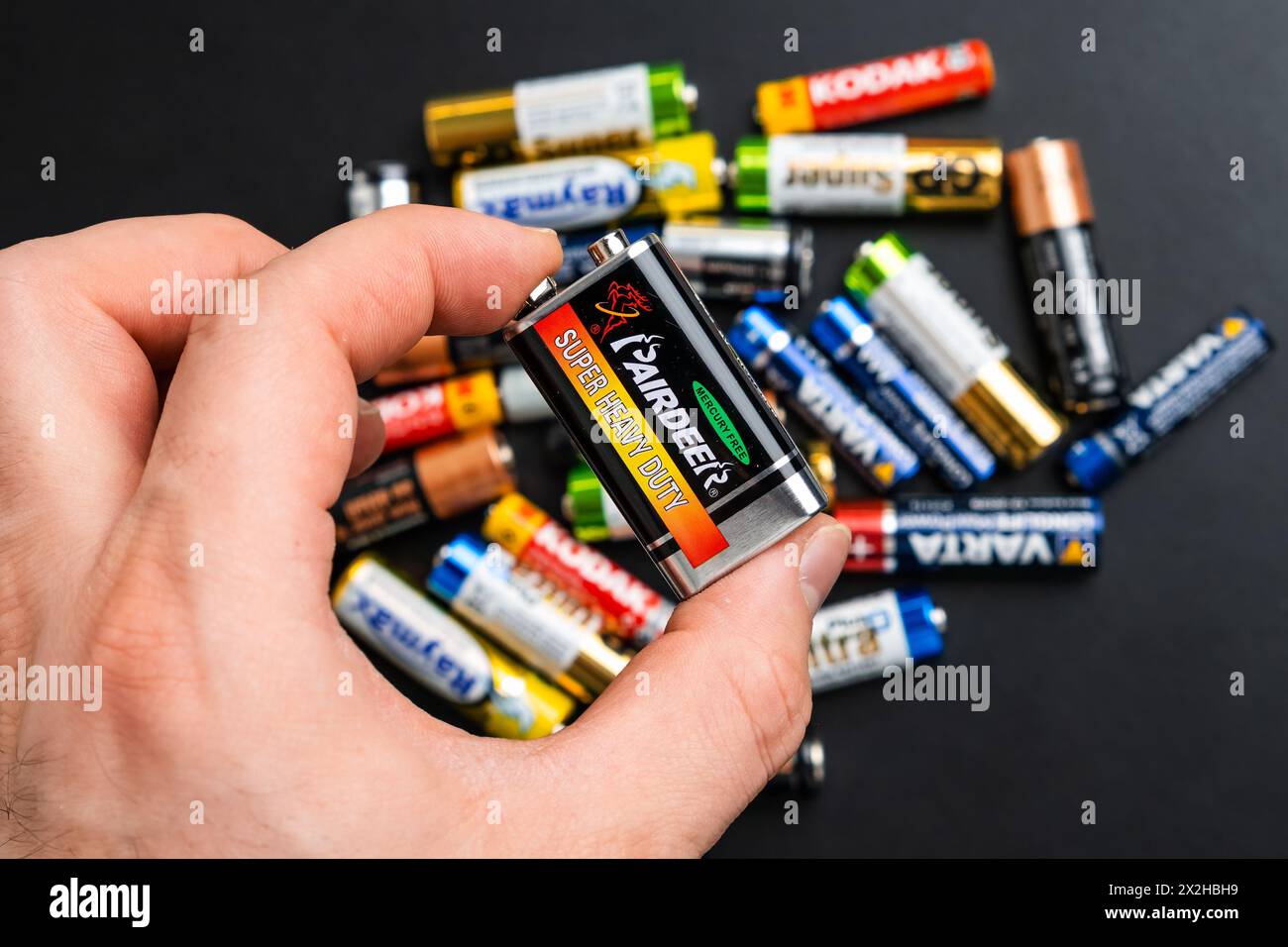 BERLIN , GERMANY - APRIL 14 2024: 9 Volt type alkaline battery in mans ...