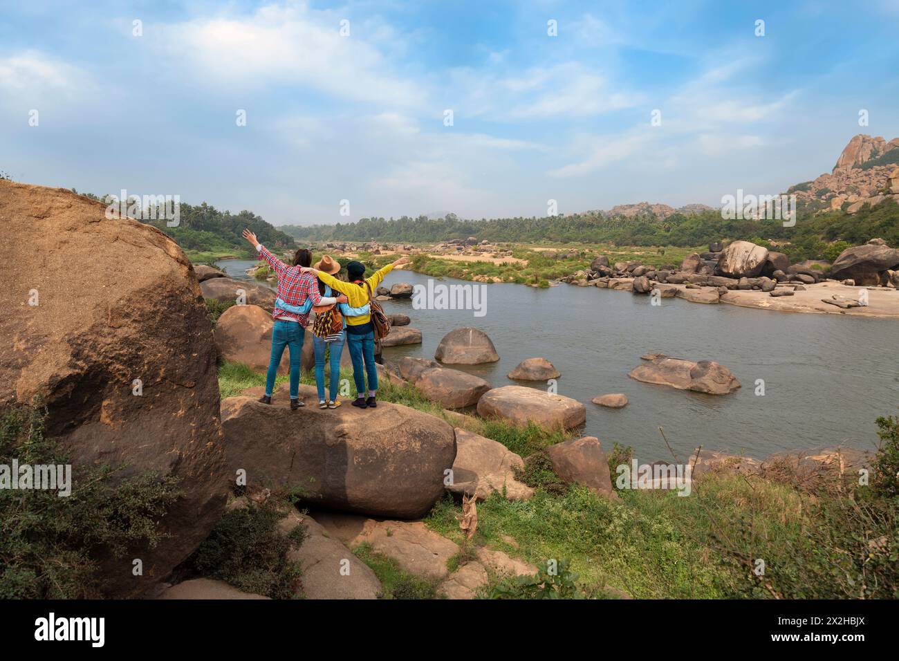 Tourists have fun on vacation at the Tungabhadra river bank with scenic ...