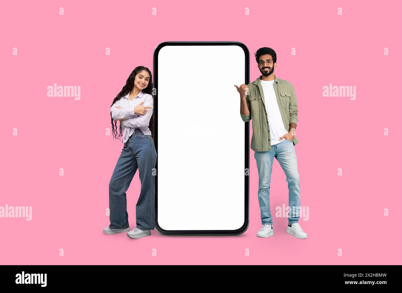 Youthful pair presenting a digital mockup display Stock Photo - Alamy