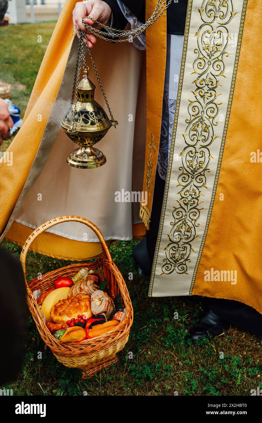 A priest consecrates a traditional Hungarian Easter basket with incense ...