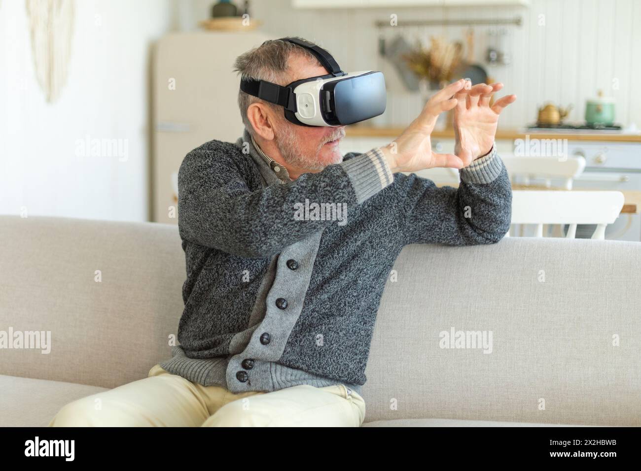 Excited mature senior man wearing using virtual reality metaverse VR ...