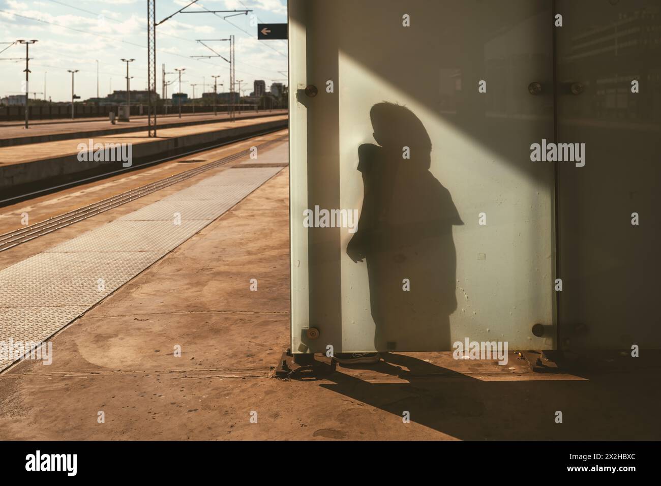 Shadow of unrecognizable human on the glass wall of the train station ...