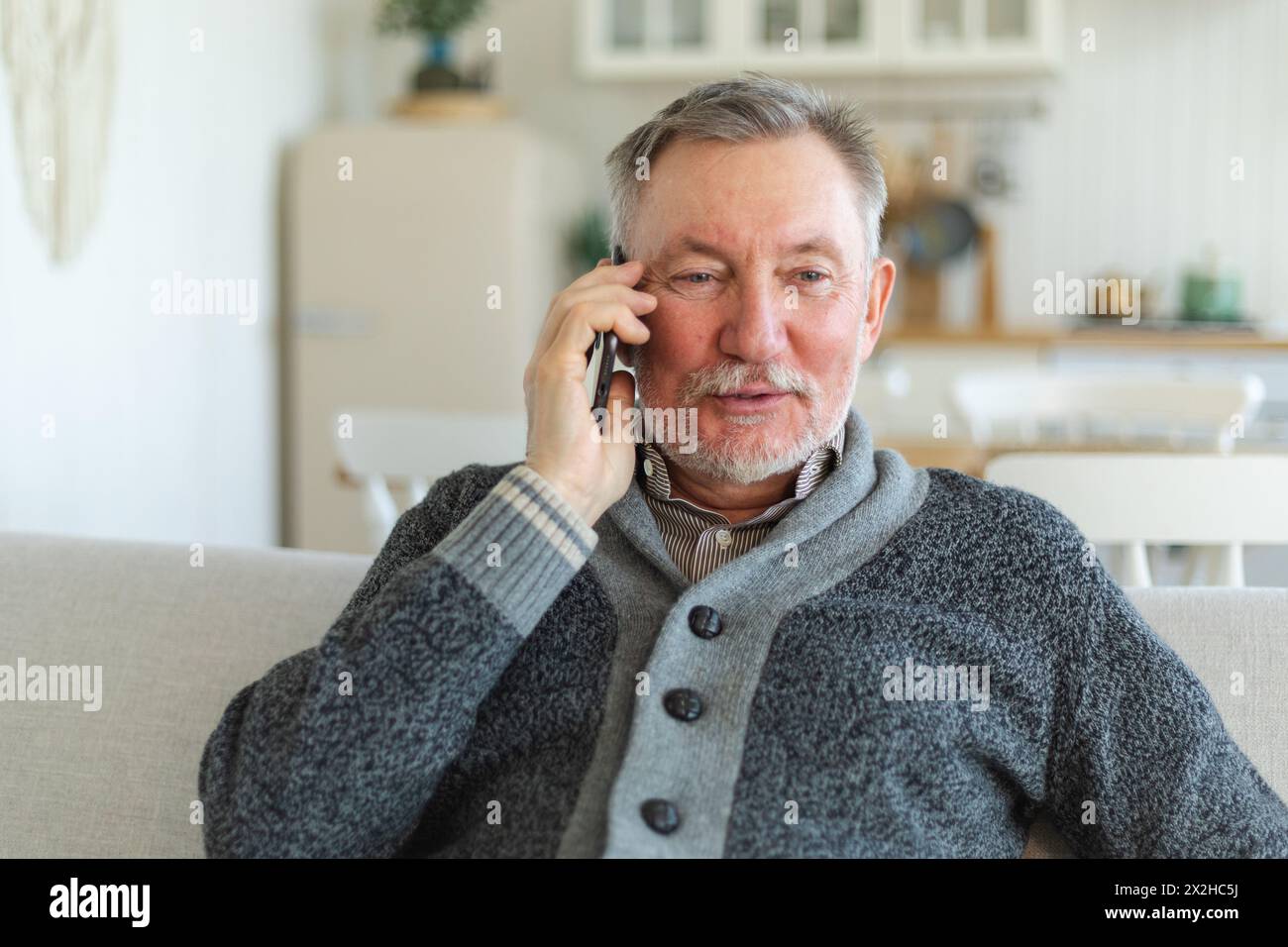 Happy middle aged senior man talking on smartphone with family friends ...