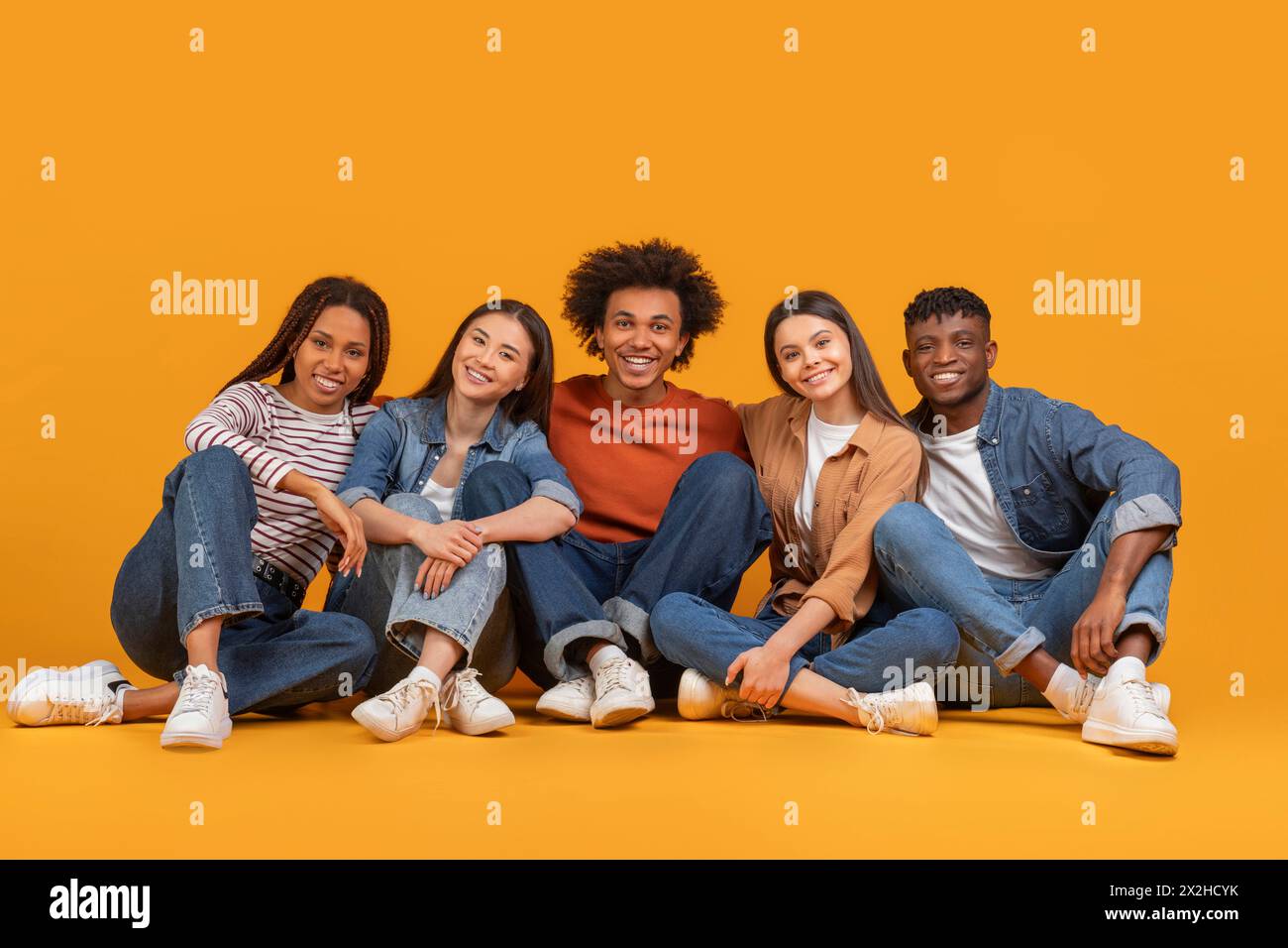 Group multiethnic friends seated hi-res stock photography and images ...