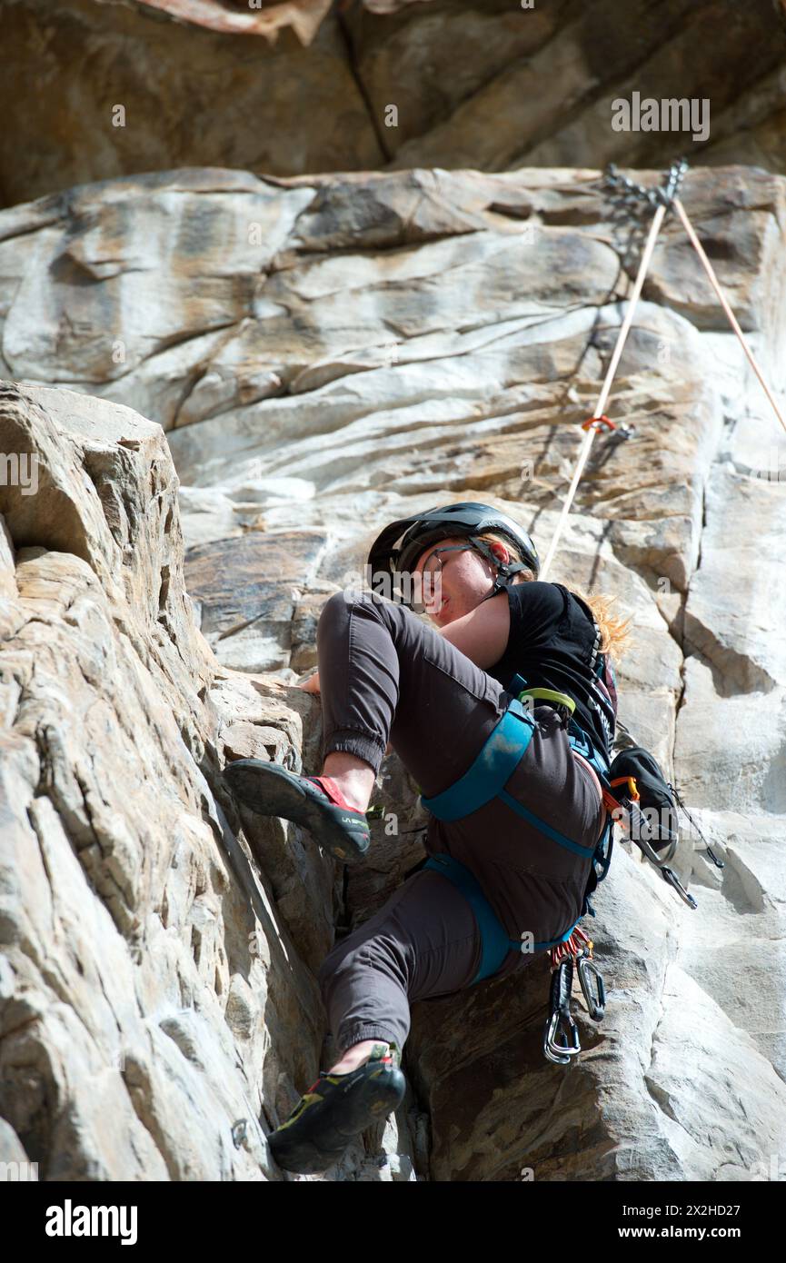 Male climber positioning foot on climb Stock Photo - Alamy