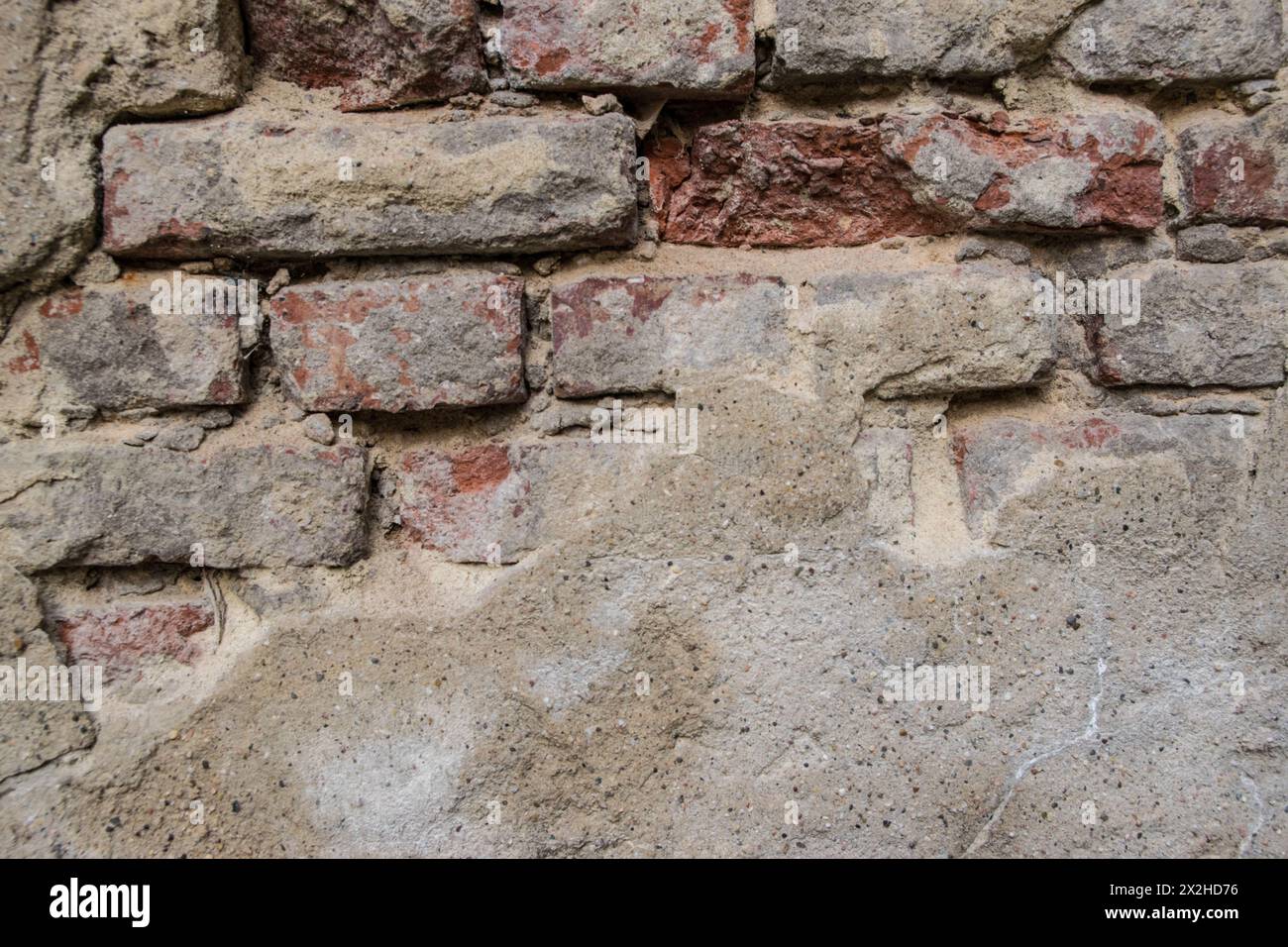 Beige structural stone wall of the ancient building consists of old ...