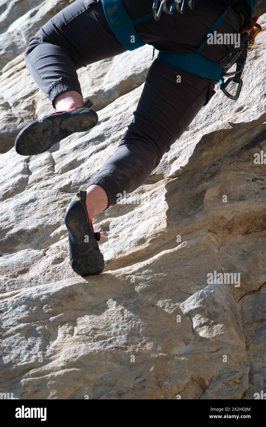 Climber legs and feet while climbing up rock face Stock Photo - Alamy