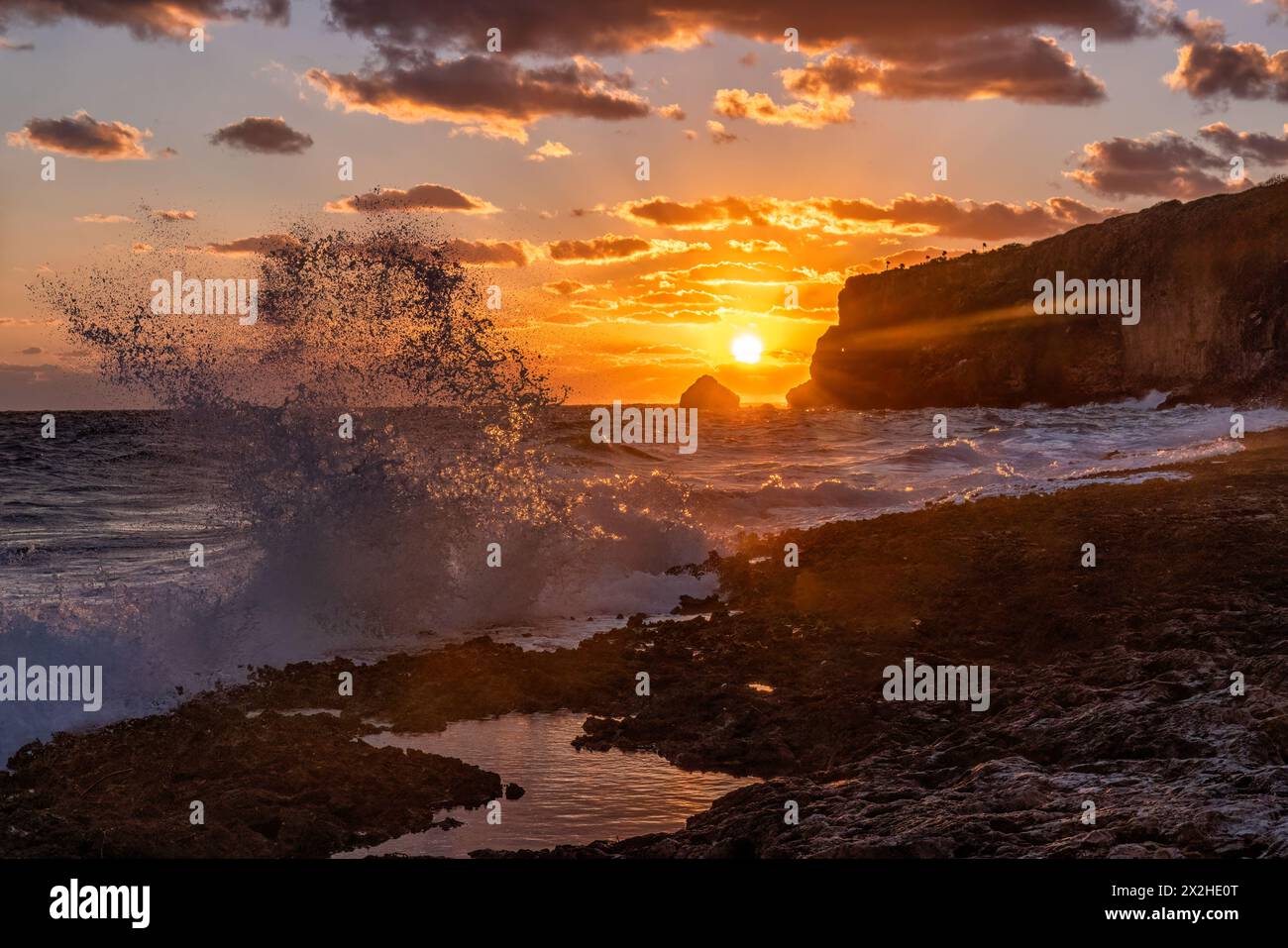 The sun rises over Little Cayman Brac off the limestone bluffs on the East End of Cayman Brac ...