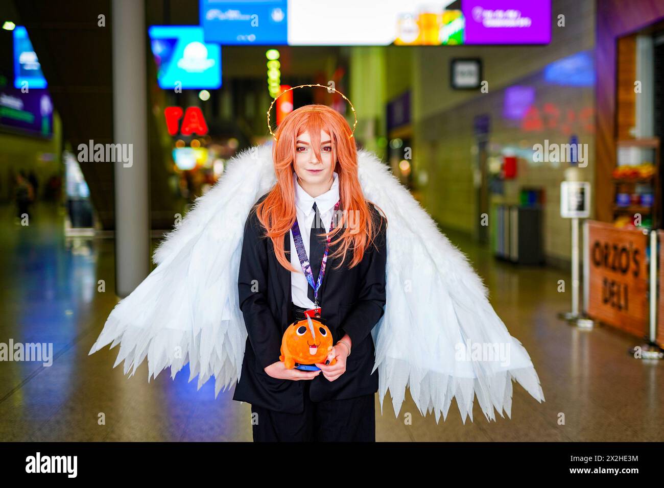 A devil angel cosplayer posing for photos at ComicCon posing for their ...
