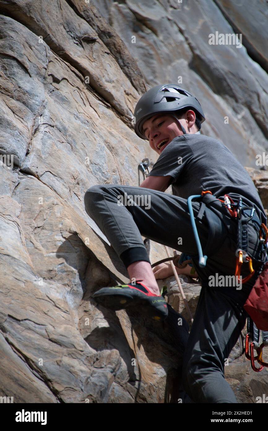 Side view of male climber looking at foot grip Stock Photo - Alamy