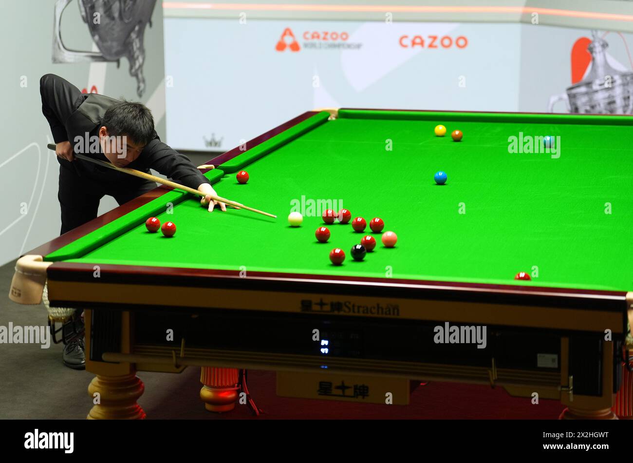 Pang Junxu in action against Robert Milkins (not pictured) on day three ...