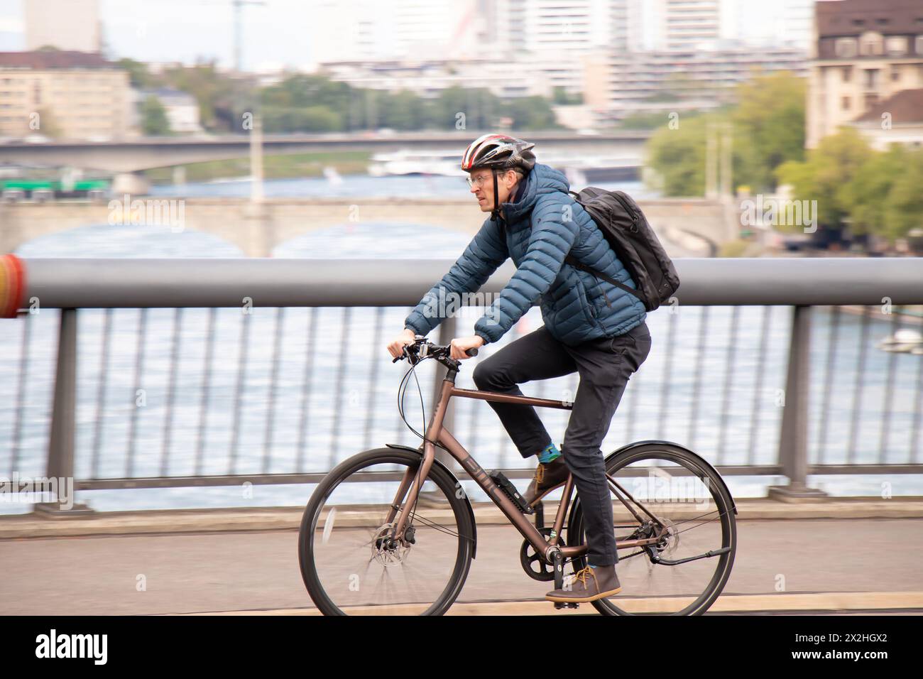 Basel, Switzerland - April 18, 2024: Mature cyclist riding bicycle on ...