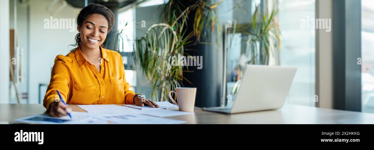 Happy black lady company worker working with documents Stock Photo - Alamy