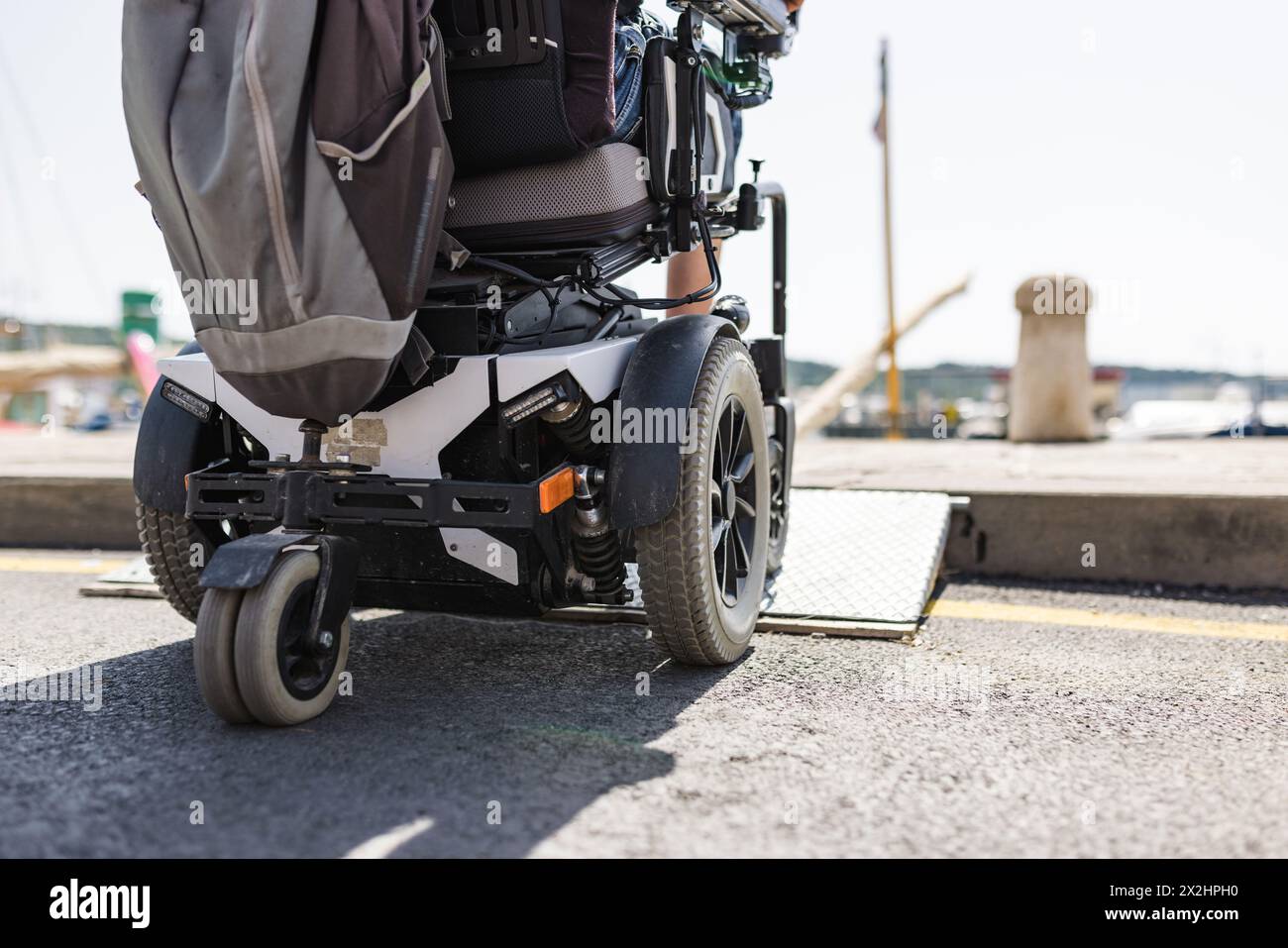 Male tourist on wheelchair crossing over the threshold ramp on the ...