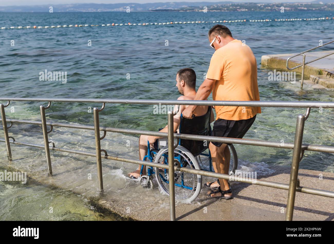 Beach wheelchair push hi-res stock photography and images - Alamy