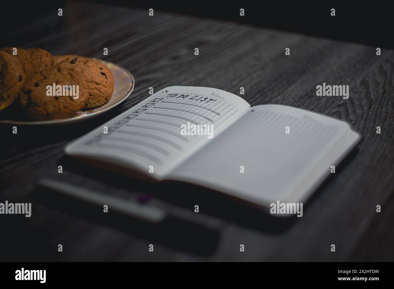 Notepad with a list of plans and a plate of cookies. High quality photo ...
