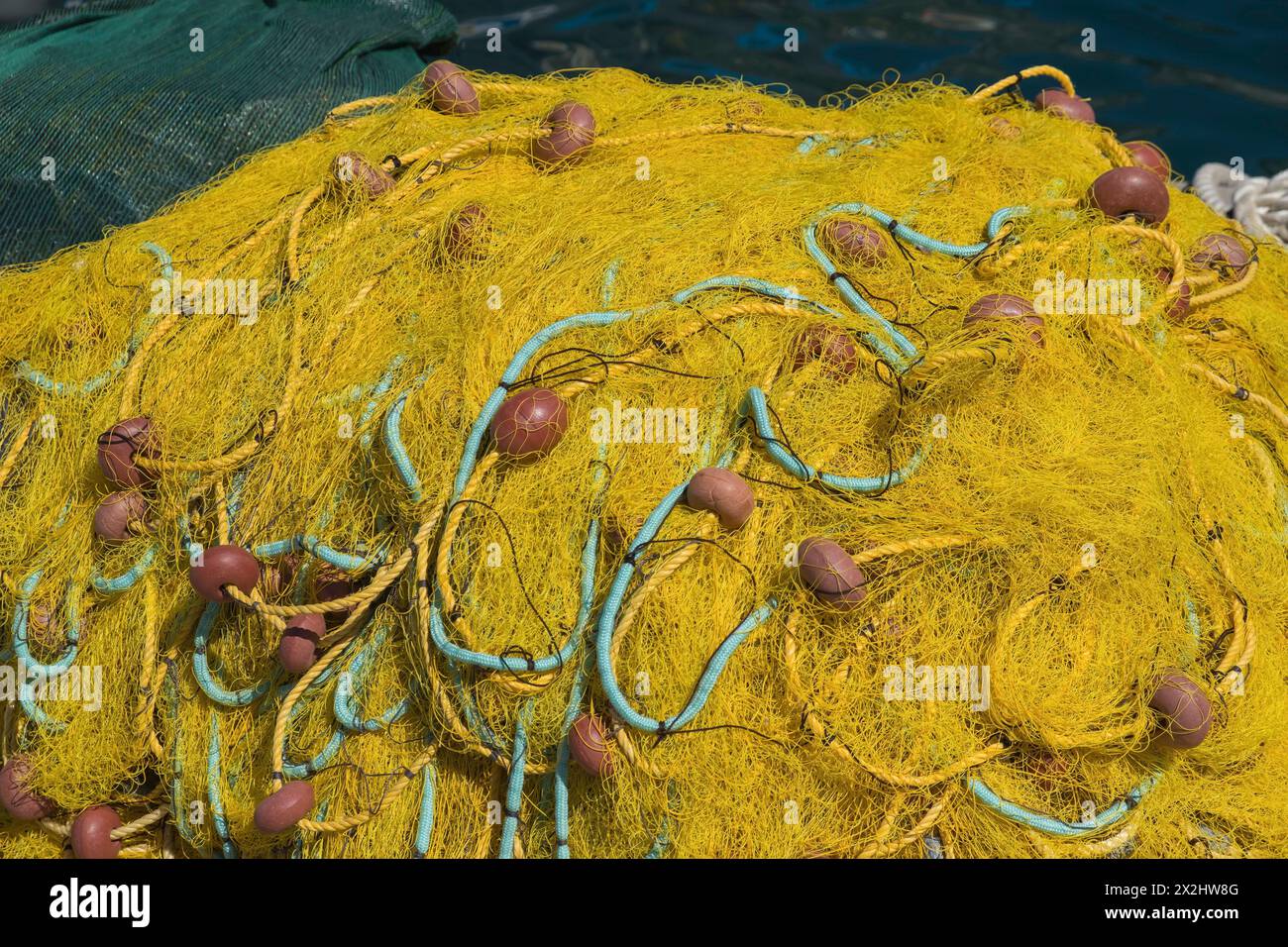 Yellow fishing nets with ropes and floats, harbour of Symi, Dodecanese, Greek Islands, Greece ...