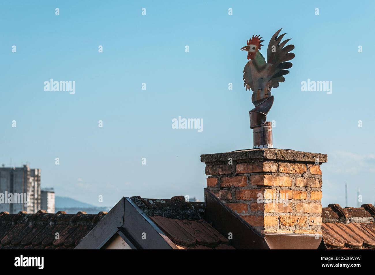 A weathercock atop a rooftop, indicating wind direction with its iconic ...