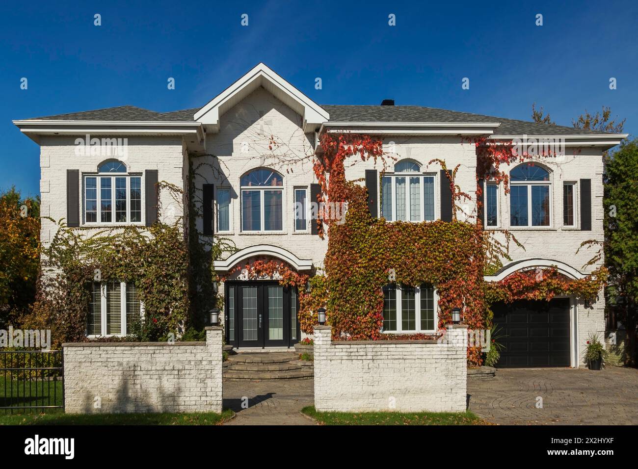 Luxurious white brick with black trim house facade covered with ...
