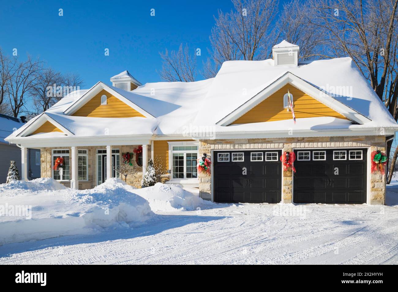 Beige and tan natural cut stone with yellow wood cladding, white and ...