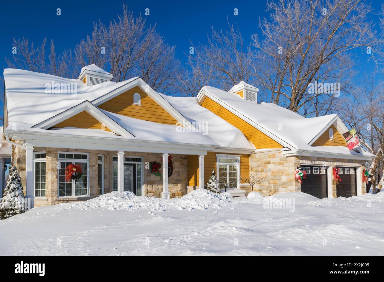 Beige and tan natural cut stone with yellow wood cladding, white and ...