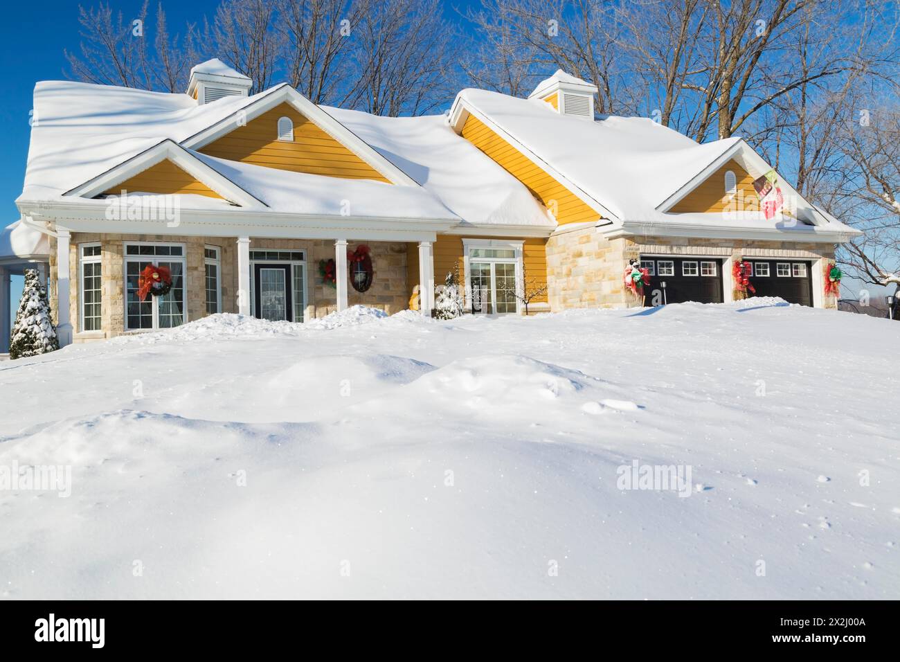 Beige and tan natural cut stone with yellow wood cladding, white and ...