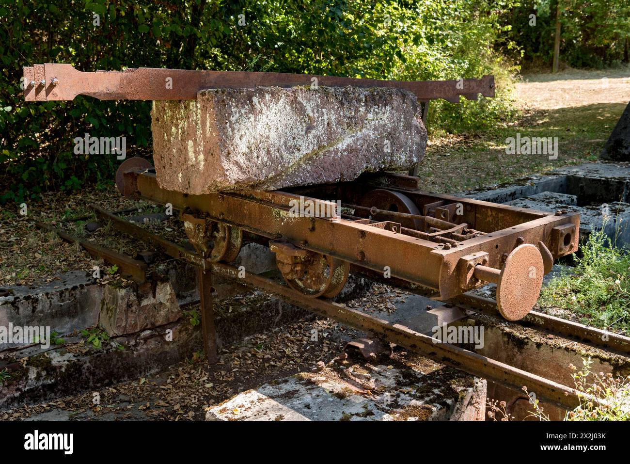 Rusty wagon, wagon on rail with block of Michelnau tuff, red basalt ...