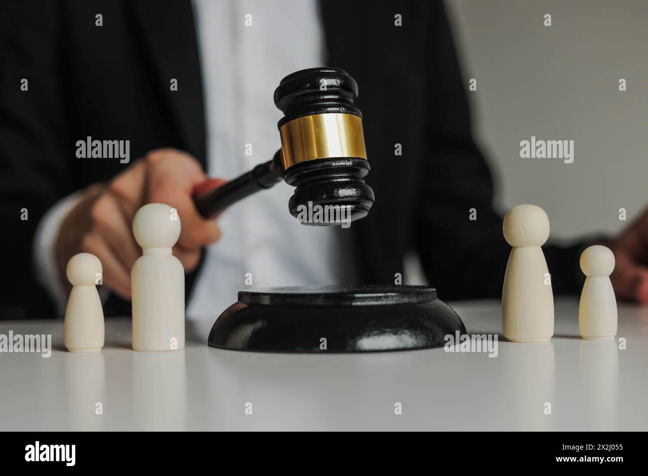Figures of family are separated by judge's gavel. Family law, divorce ...