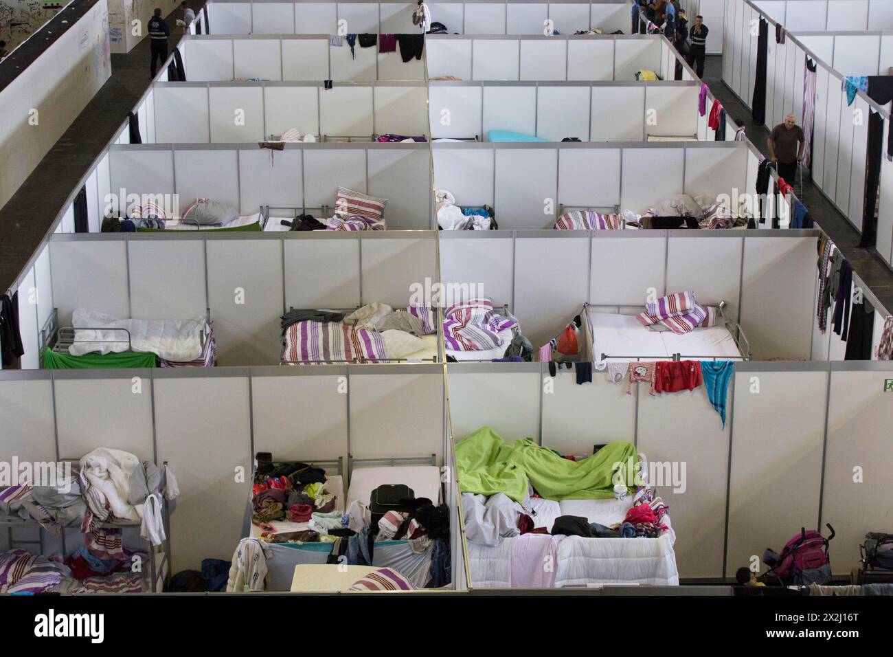 Temporary rooms with beds are set up in an emergency shelter for ...
