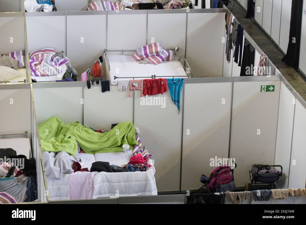 Temporary rooms with beds are set up in an emergency shelter for ...