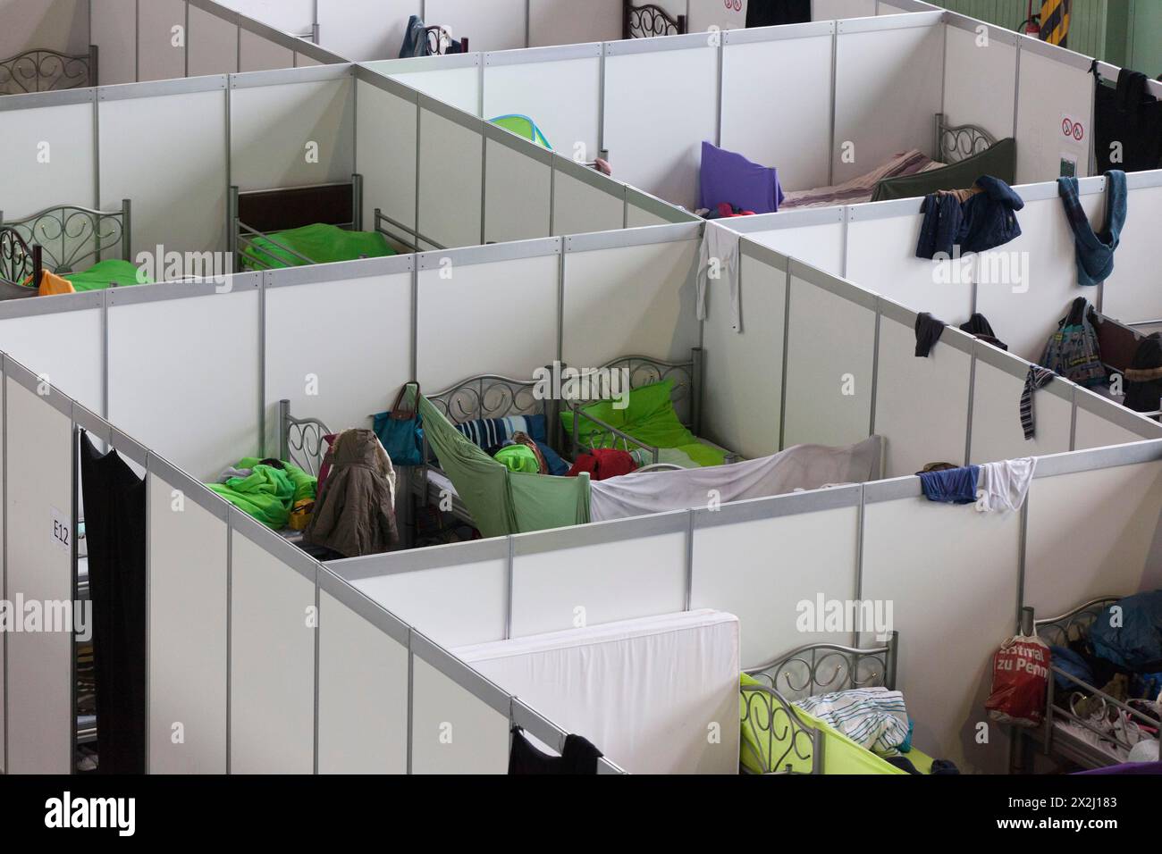 Temporary rooms with beds are set up in an emergency shelter for ...