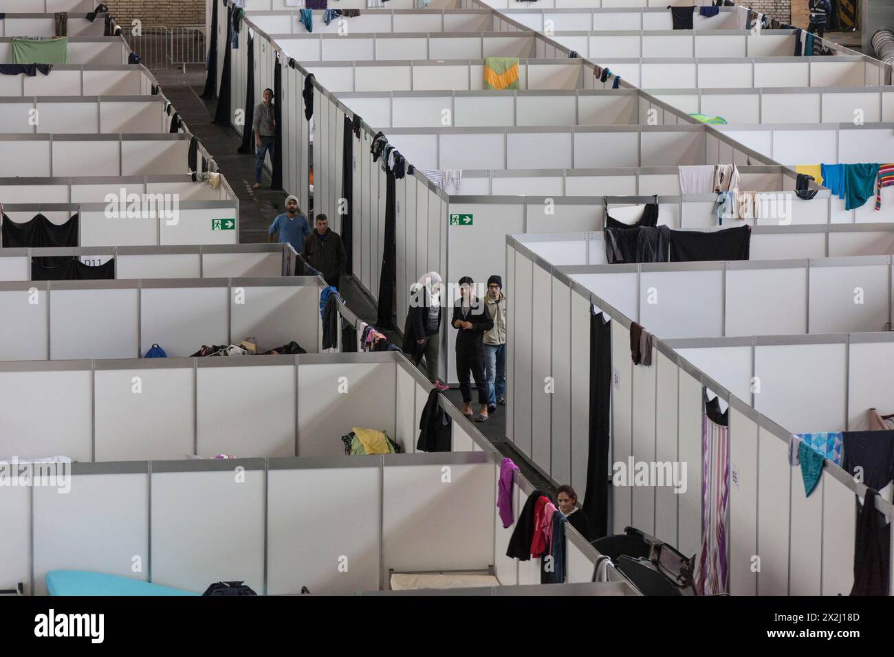 Temporary rooms with beds are set up in an emergency shelter for ...