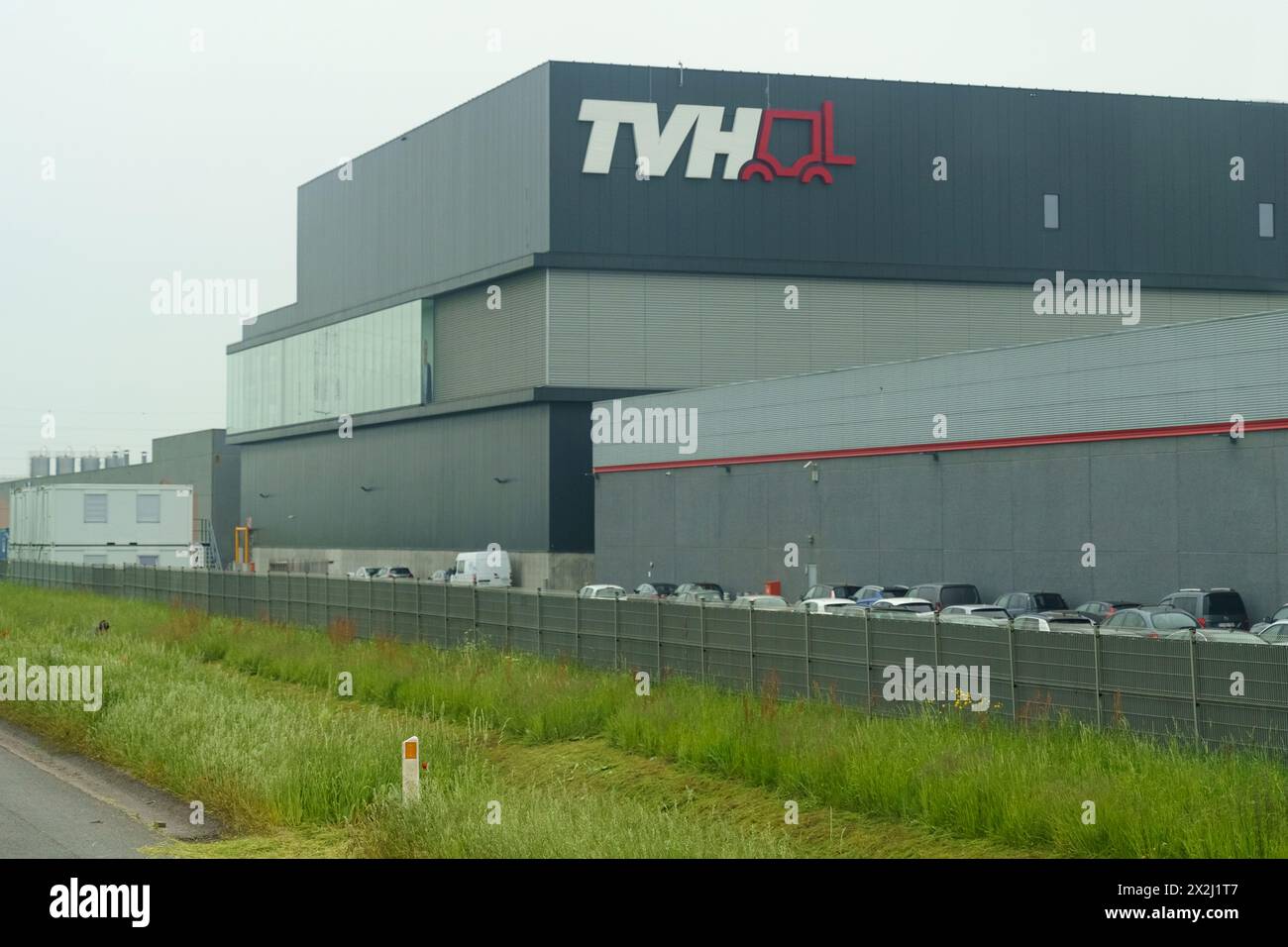 Kortrijk, Belgium - May 22, 2023:The grey facade of the TVH warehouse ...