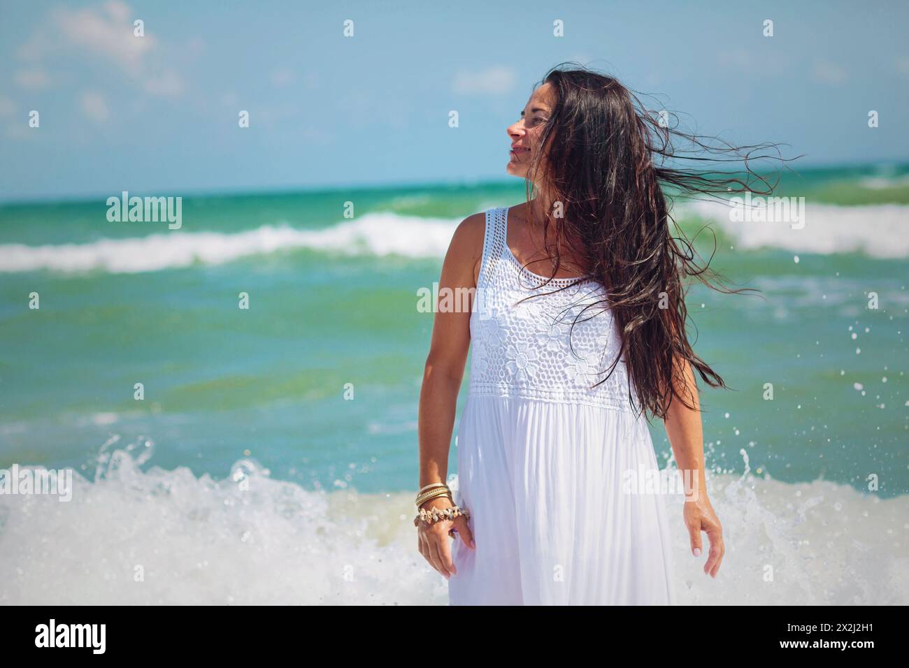 Coastal Tranquility: Mature Woman's Sunny Promenade Stock Photo - Alamy