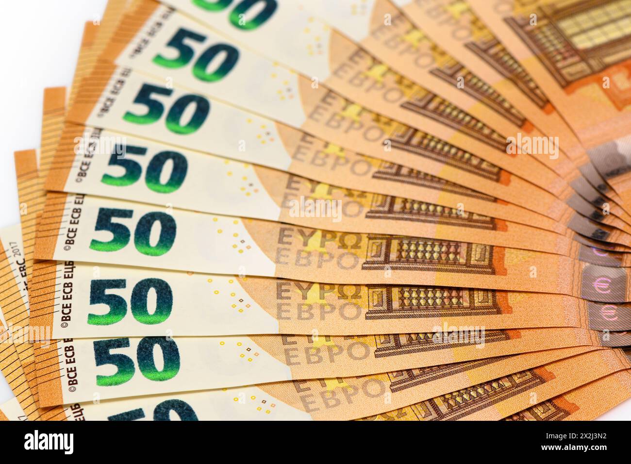 close-ups of a fan of 50 Euro bank notes isolated over white background ...