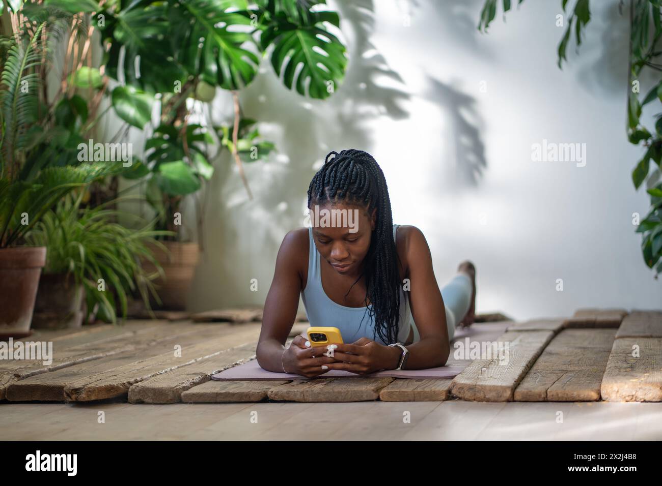 Sported black woman use smartphone take break from workout yoga, rest ...
