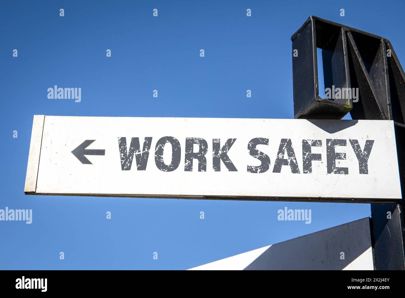 Work Safety. White signpost and blue sky Stock Photo - Alamy