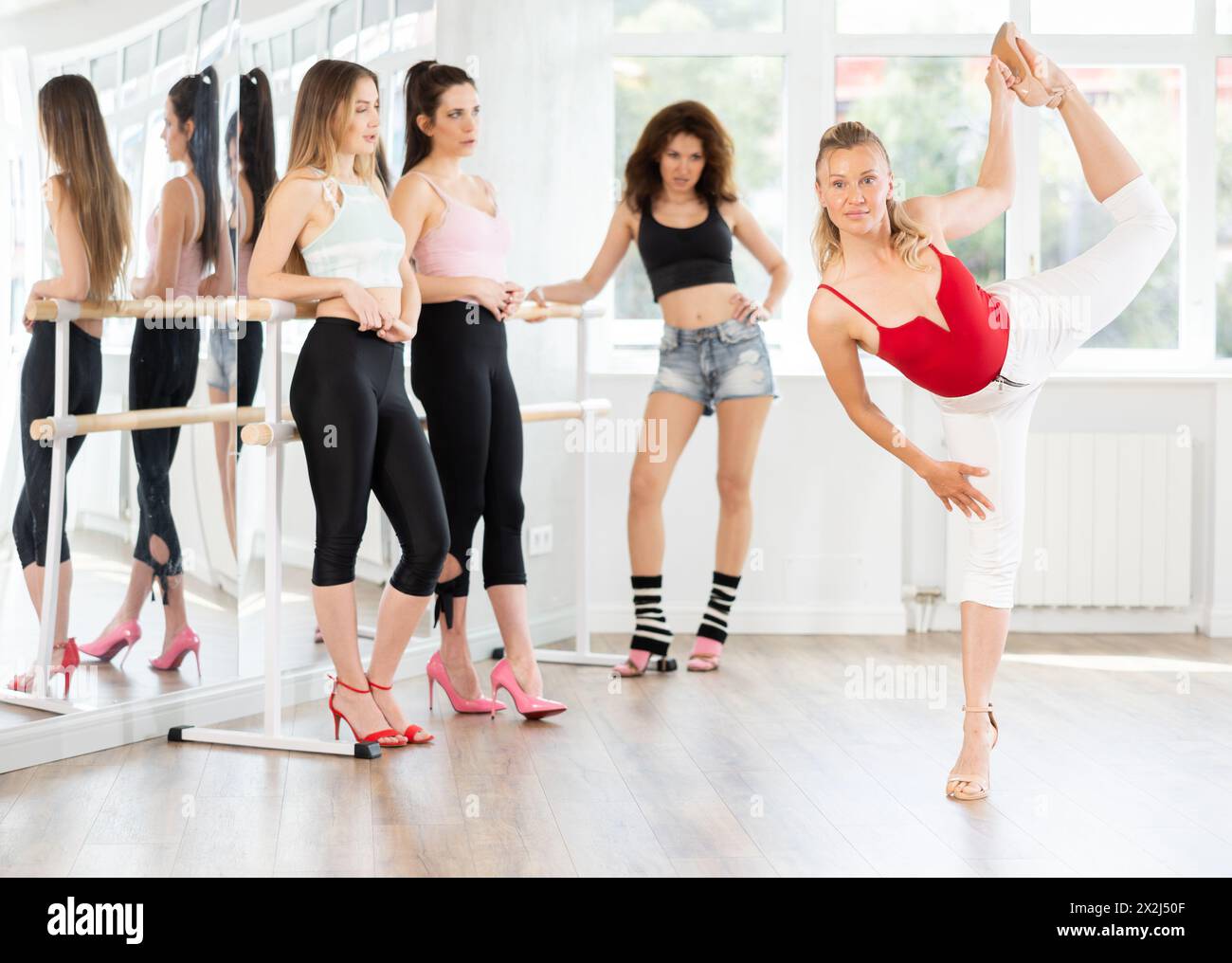 Visitors to choreographic class, observe professional rendering of ...