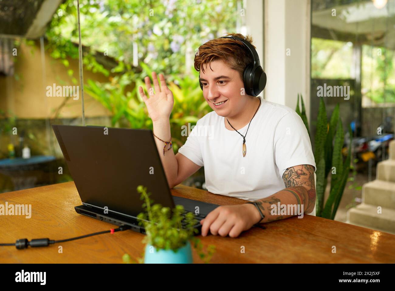 Smiling Gen Z Transgender pro in casual attire enjoys video call on ...