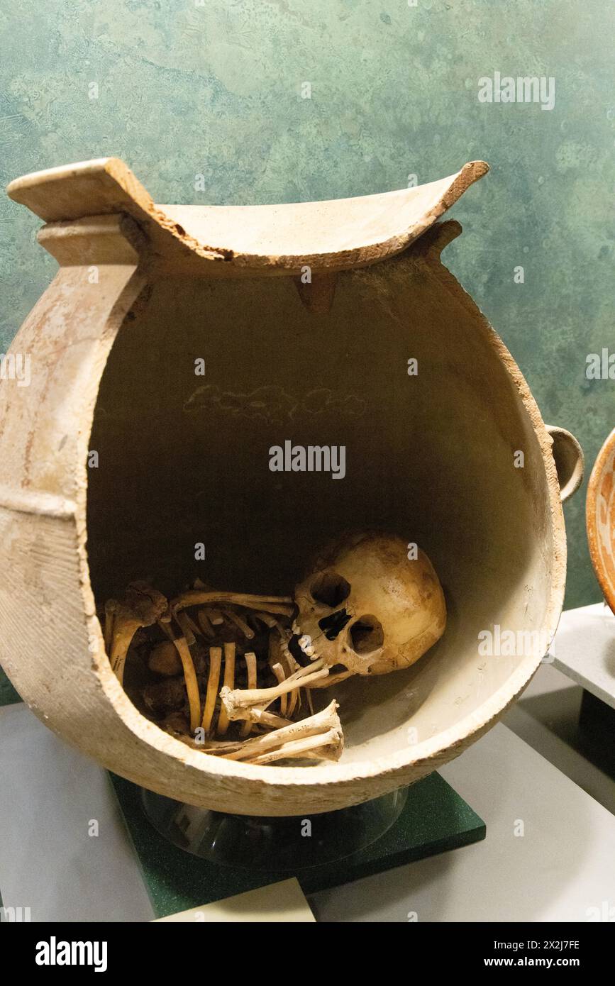 The burial of a Mayan infant, in a clay vessel covered with a plate or ...