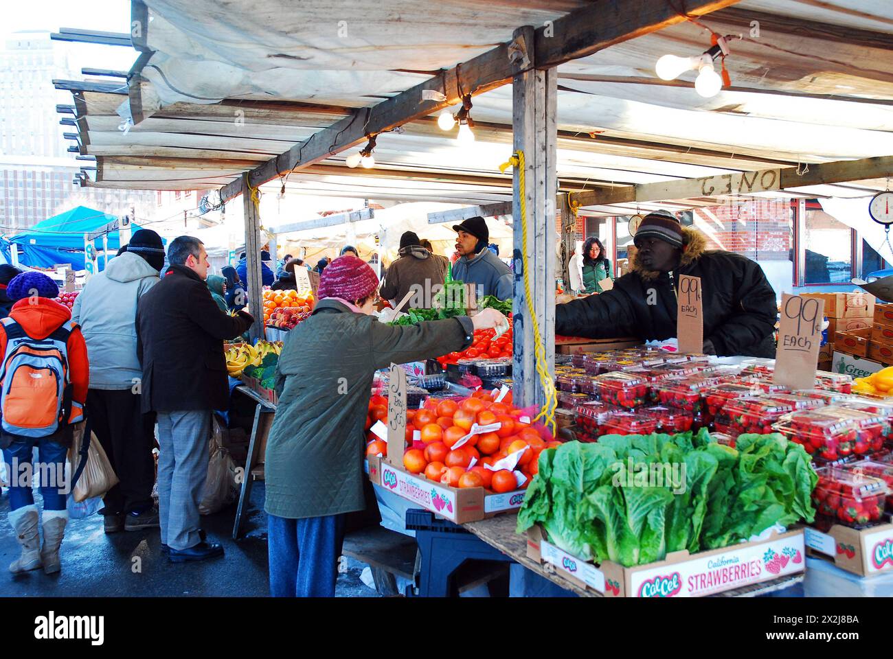 Shoppers seek fresh fruit on a cold winter’s day in the Haymarket, a ...