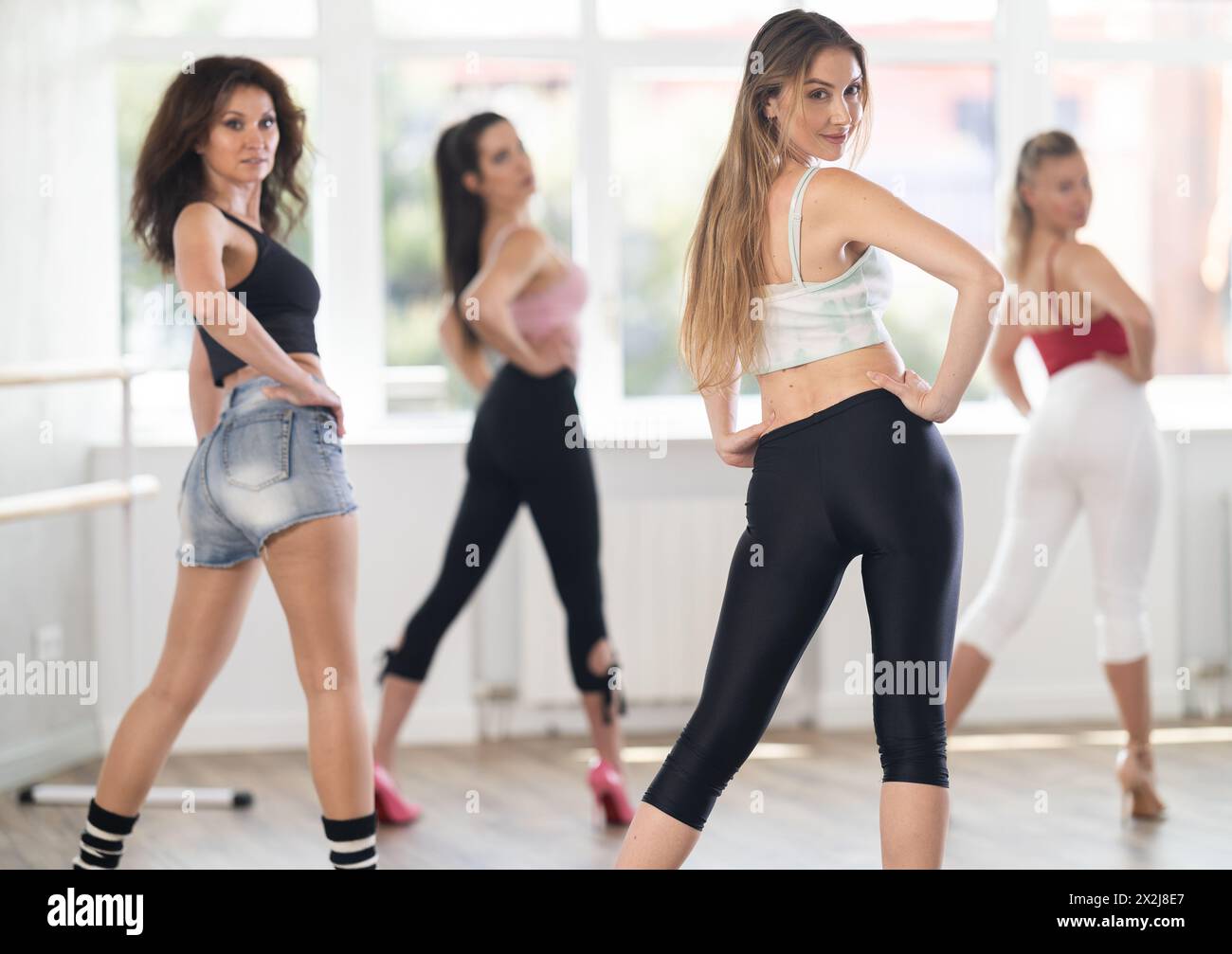 Young woman standing half-turned with back to camera at stiletto dance ...