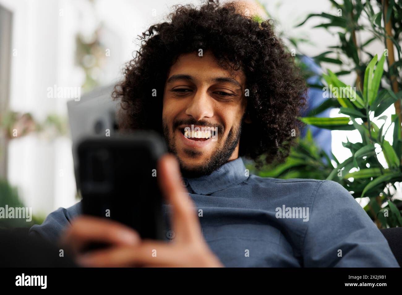 Arab businessman browsing internet on smartphone while relaxing in ...