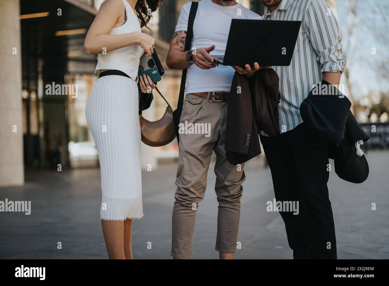 Cross-generational business executives discussing strategy in the city ...