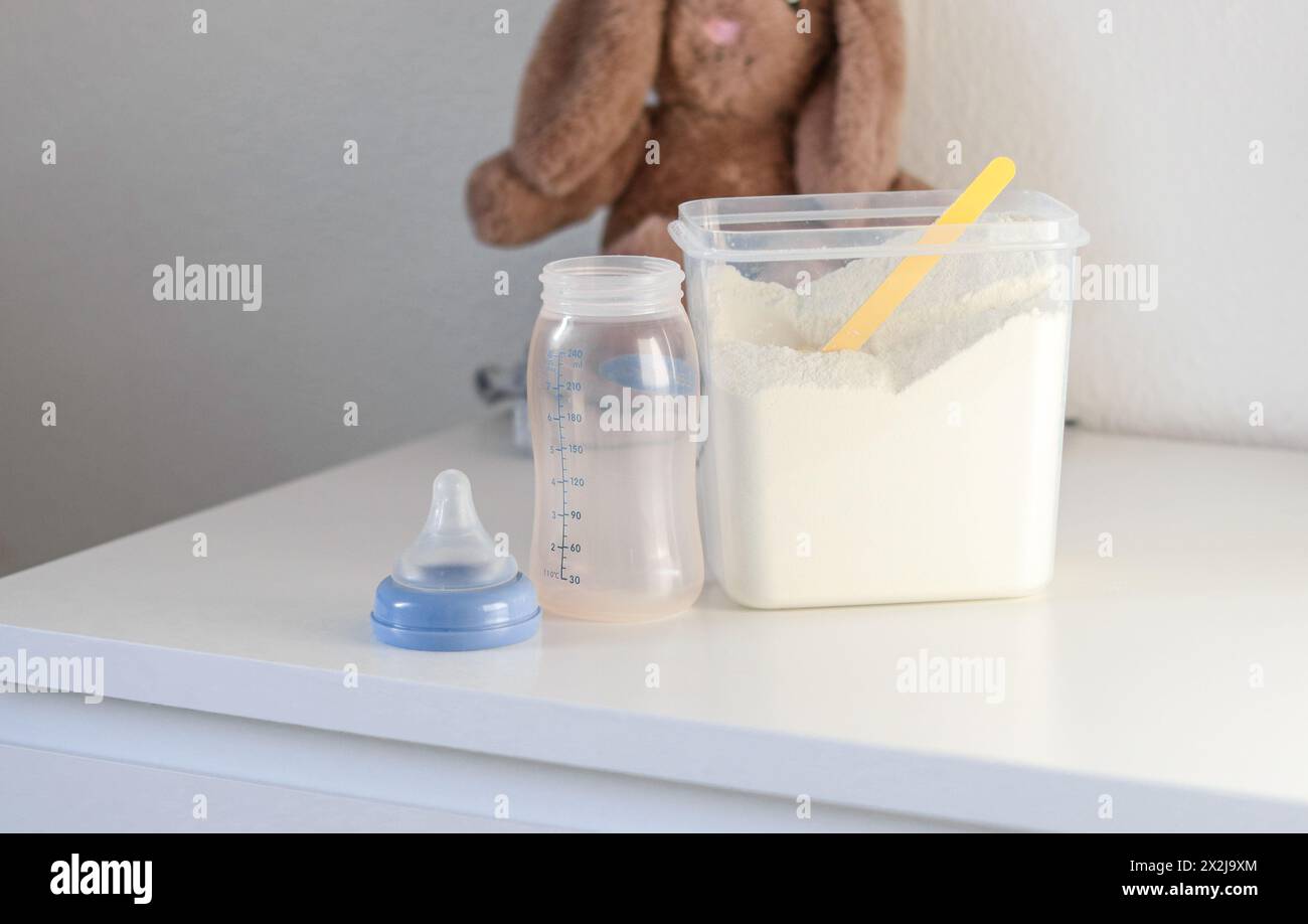 Dry powder formula milk for feeding babies in a can with yellow plastic ...